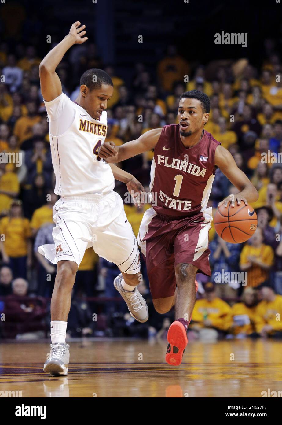 Florida State guard Devon Bookert (1) drives against Minnesota guard ...