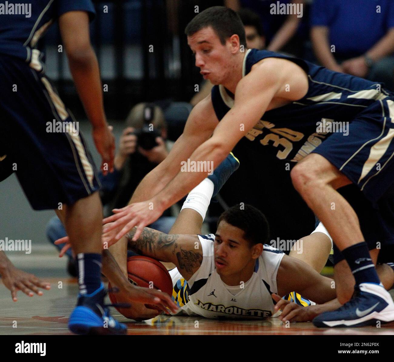 Marquette forward Juan Anderson (10) battles for the ball with George ...