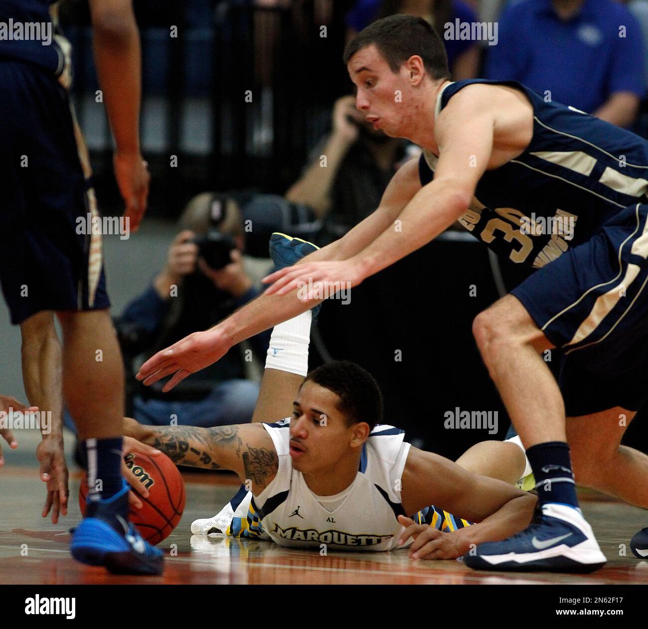 Marquette forward Juan Anderson, left, battles for the ball while on ...