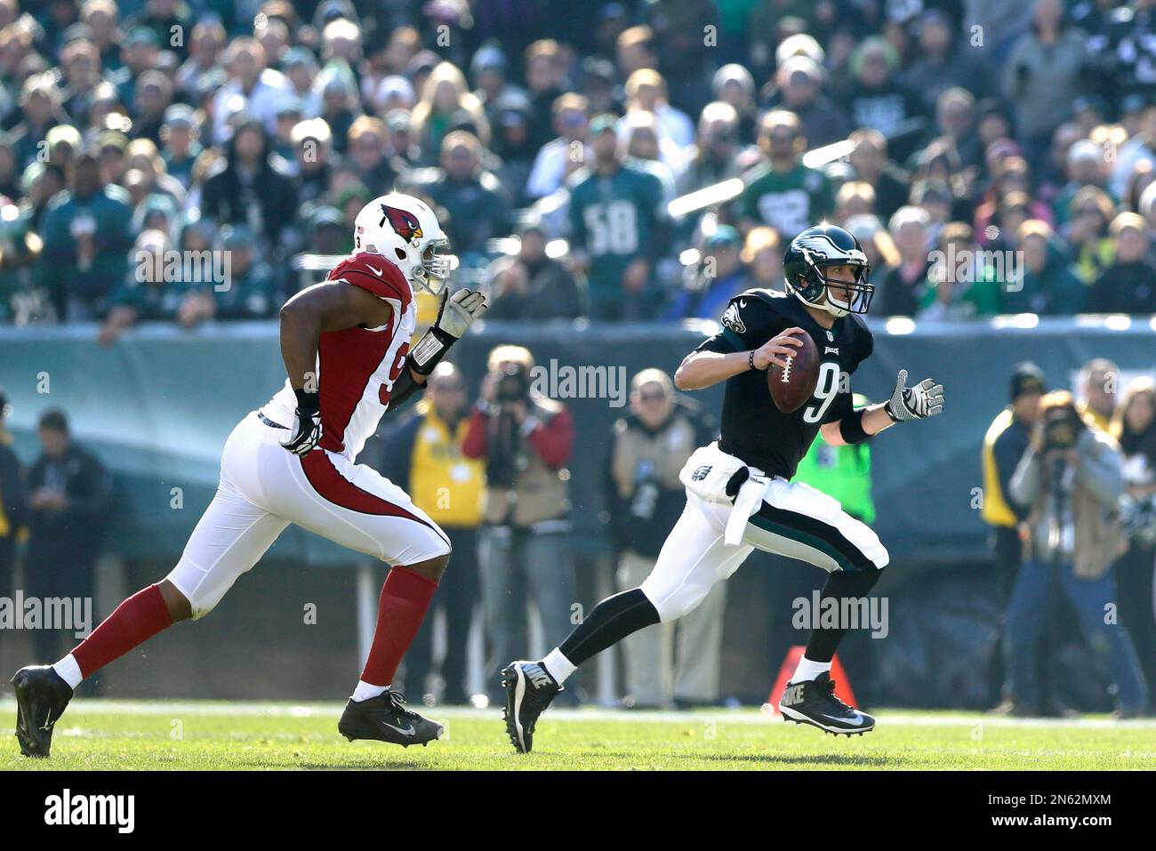 Philadelphia Eagles' Nick Foles, right, scrambles away from Arizona ...