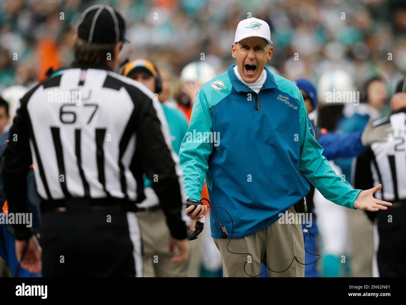 Miami Dolphins head coach Joe Philbin, right, talks to side judge Doug ...