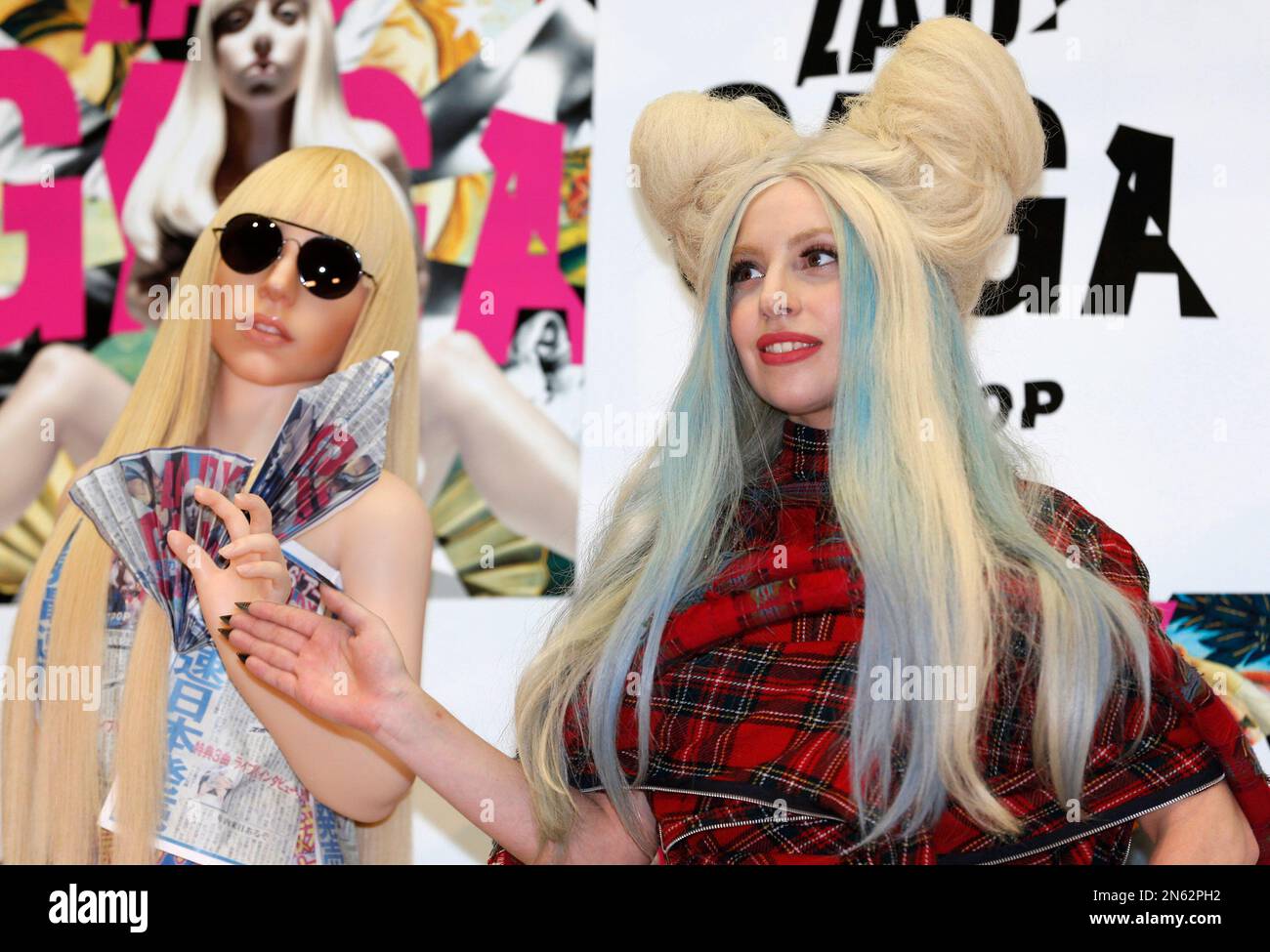 Lady Gaga poses for photographers with her life-sized doll during a ...