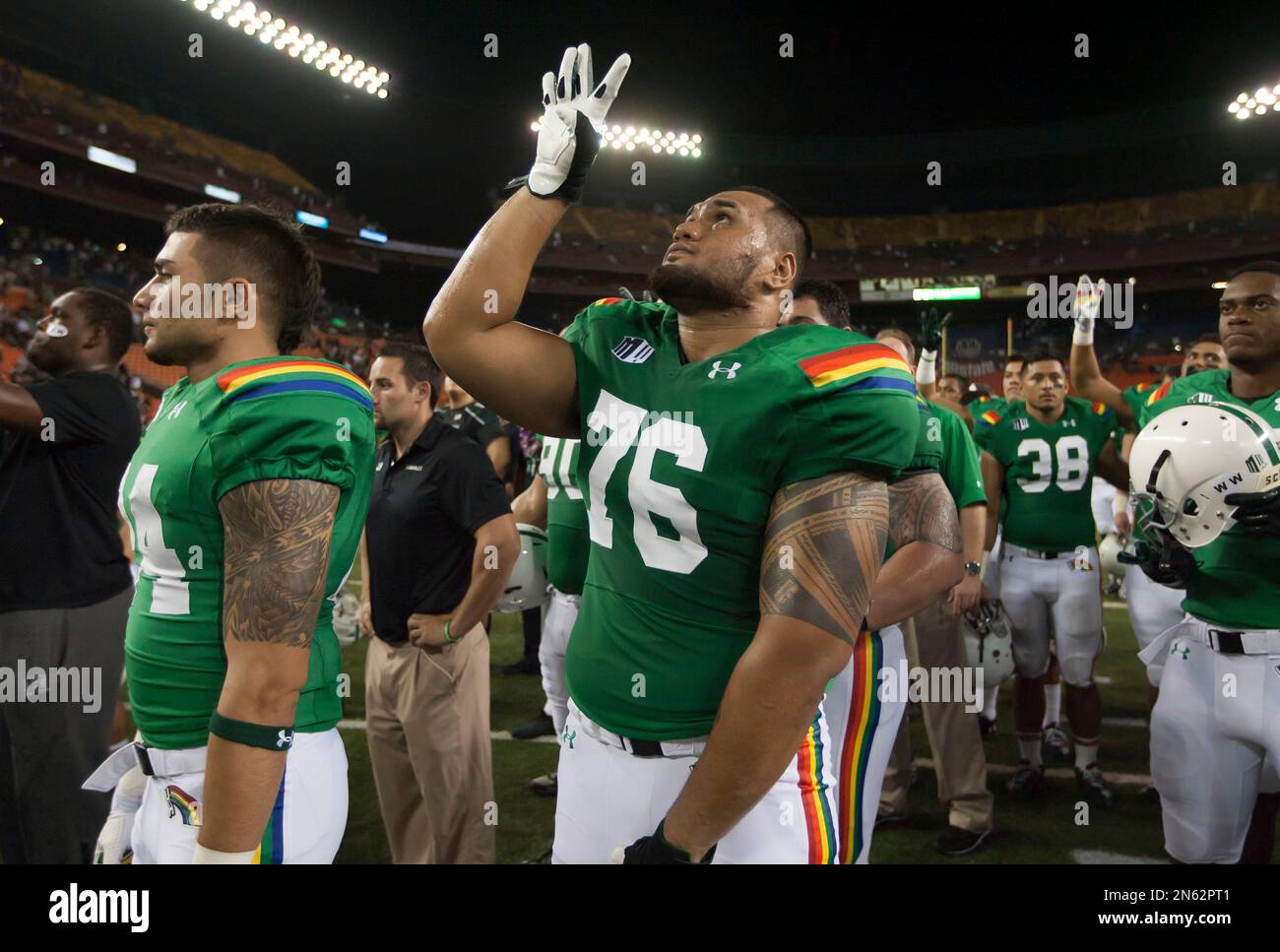Hawaii offensive linesman Dave Lefotu (76) looks to the night sky and ...