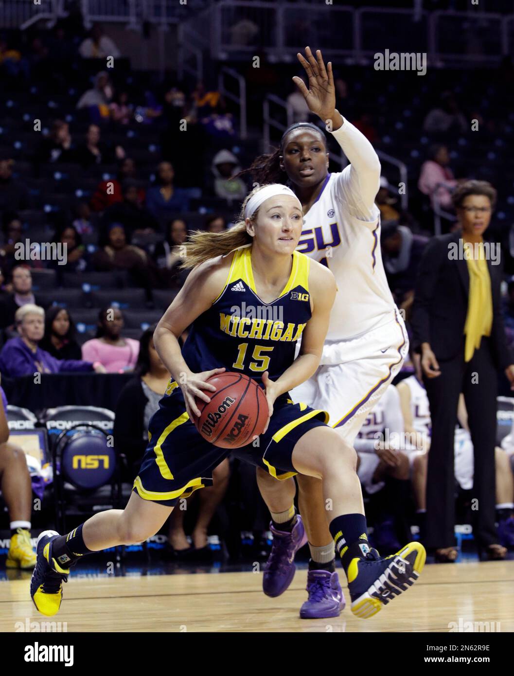 Michigan guard Paige Rakers (15) drives as LSU forward Shanece McKinney ...