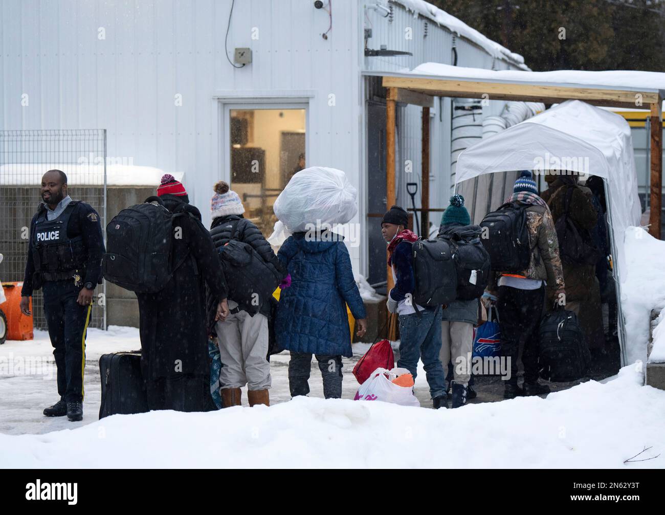 Asylum seekers cross the border at Roxham Road into Canada Thursday ...