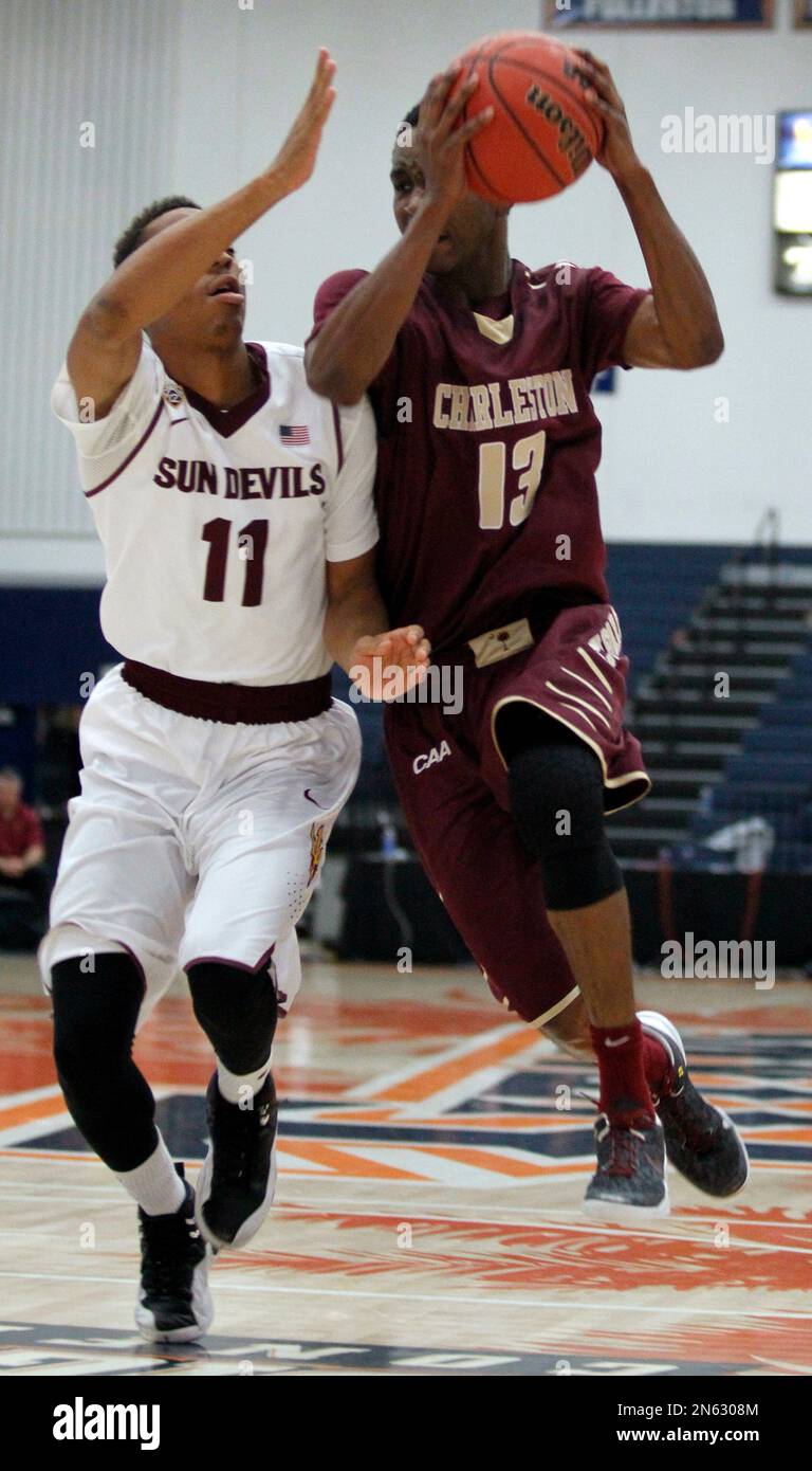College of Charleston guard Joe Chealey (13) leaps to drive to the ...