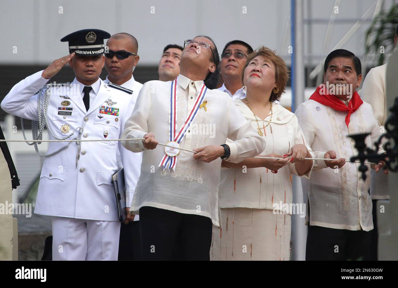 Philippine President Benigno Aquino III, second from left, raises the ...