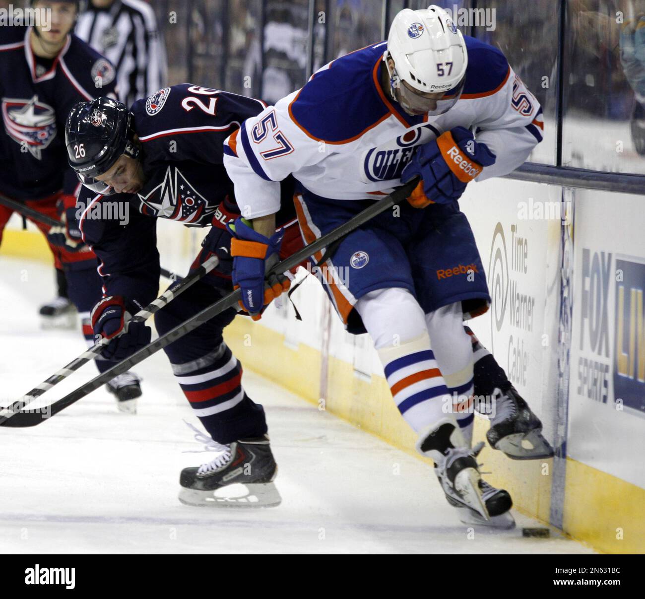 Columbus Blue Jackets' Corey Tropp, left, works for the puck against ...