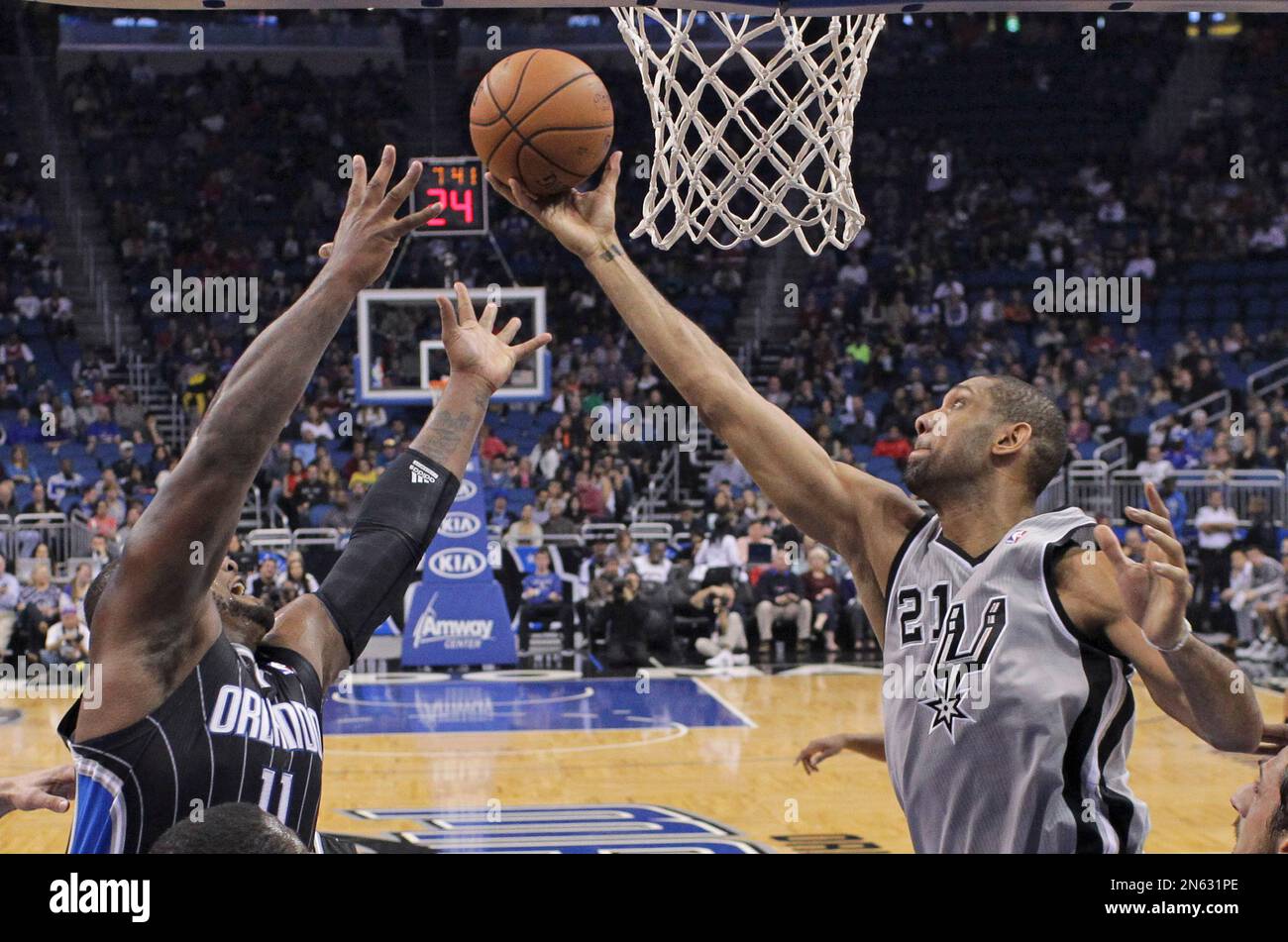San Antonio Spurs' Tim Duncan (21) goes up for a shot as Orlando Magic ...
