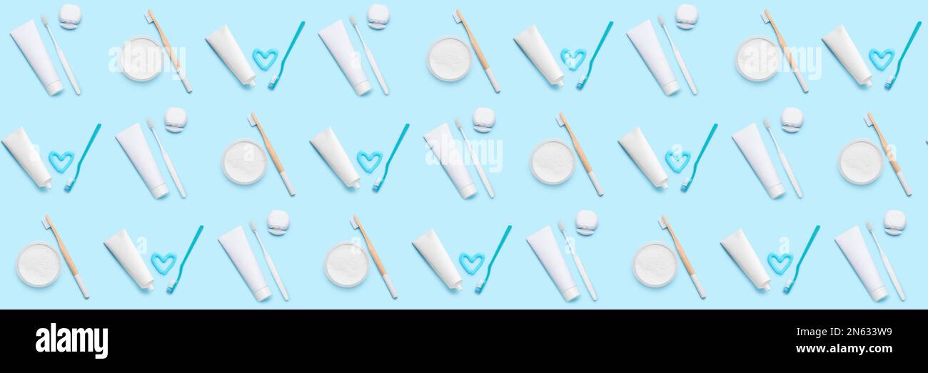 Many toothbrushes with paste, powder and dental floss on blue ...