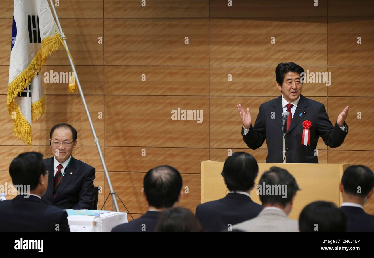 Japanese Prime Minister Shinzo Abe, right, gives a speech as Hwang Woo ...