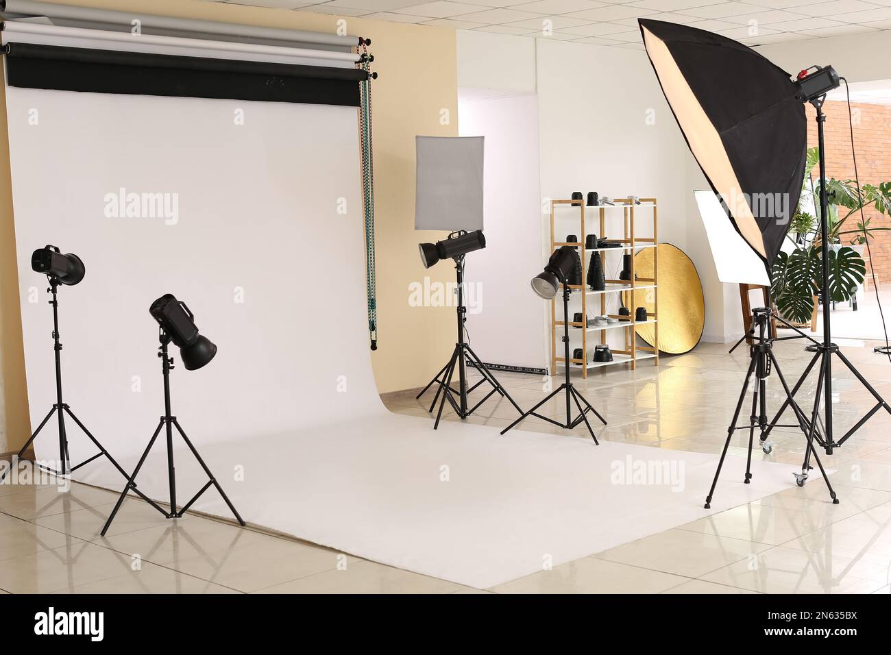 Interior of modern photo studio with white cyclorama and equipment ...