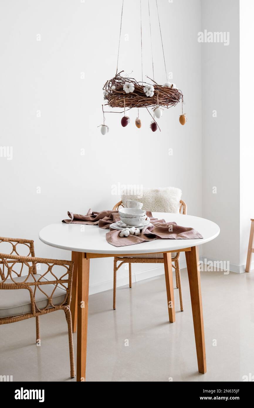 Stylish interior of dining room with beautiful Easter decor Stock Photo ...
