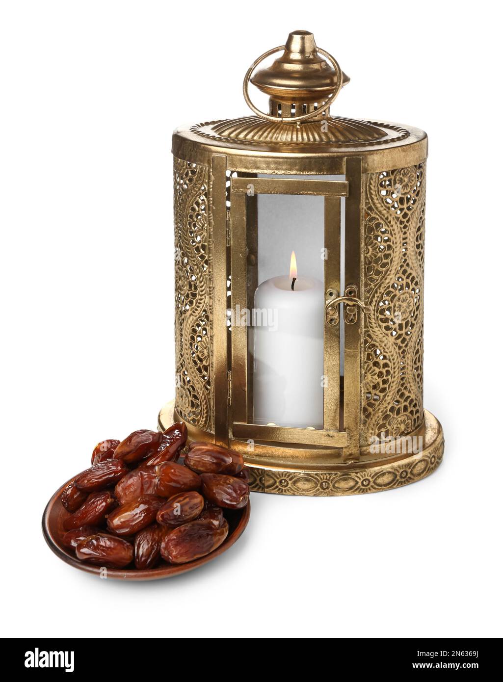 Muslim lantern with burning candle and dates for Ramadan on white ...