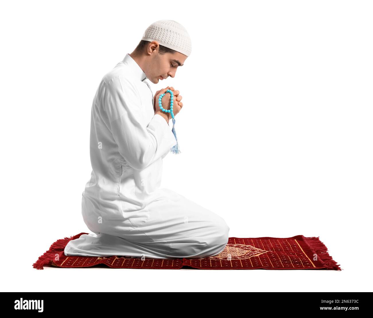 Praying Muslim man on white background Stock Photo - Alamy