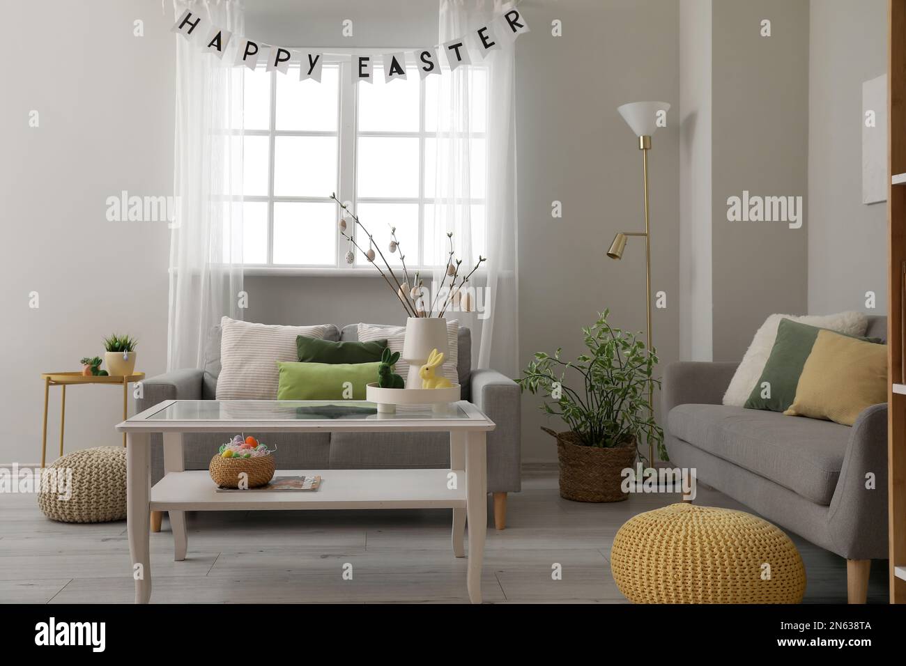 Interior of living room with Easter decor, table and sofas Stock Photo ...