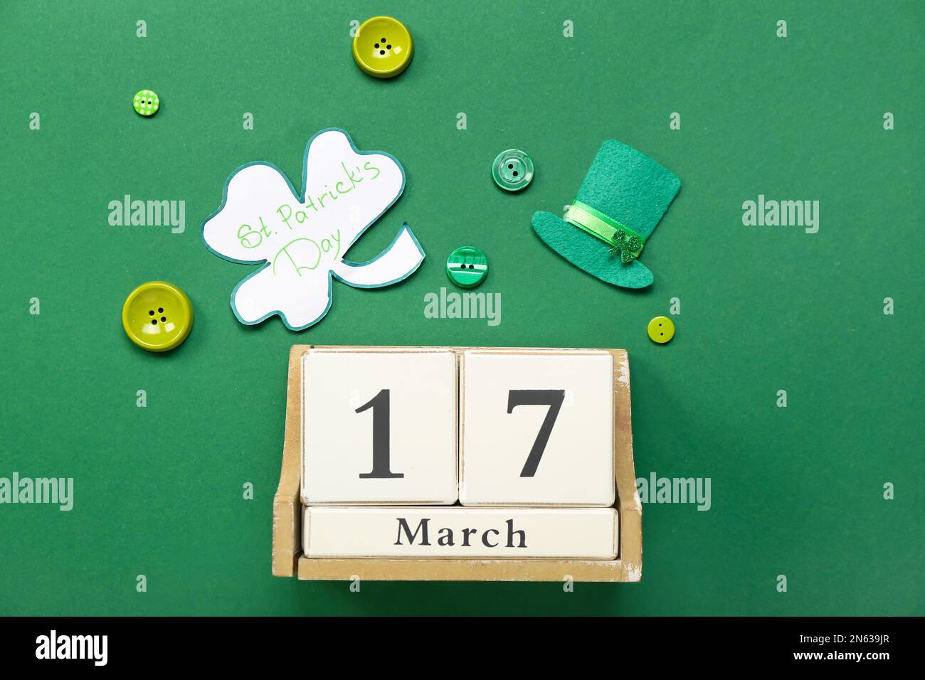 Calendar with date of St. Patrick's Day, paper leprechaun hat, clover ...
