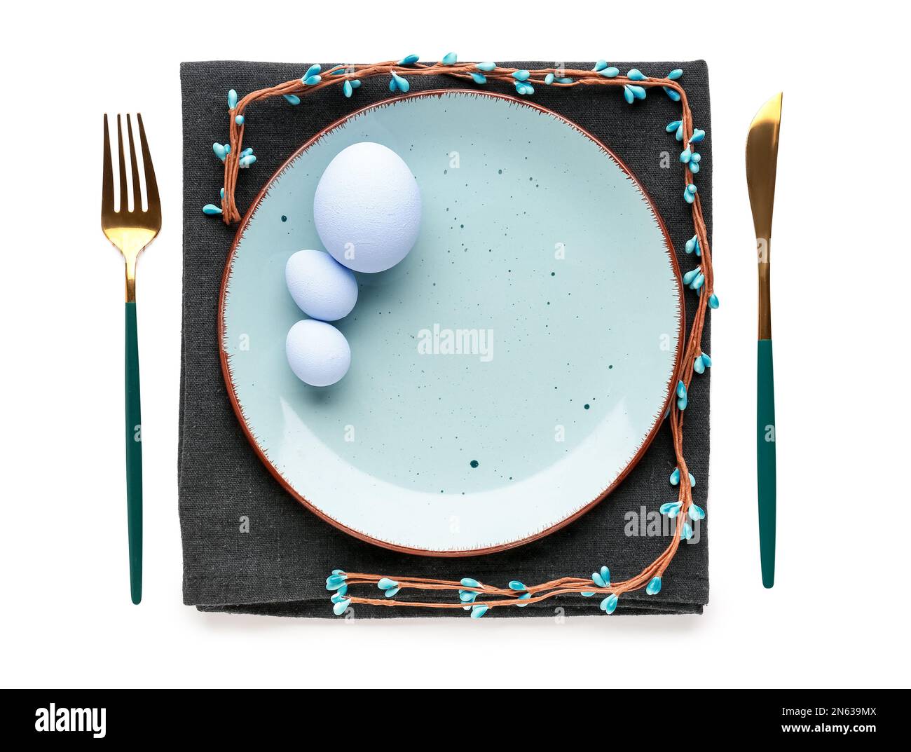 Table setting with Easter eggs and cutlery isolated on white background ...