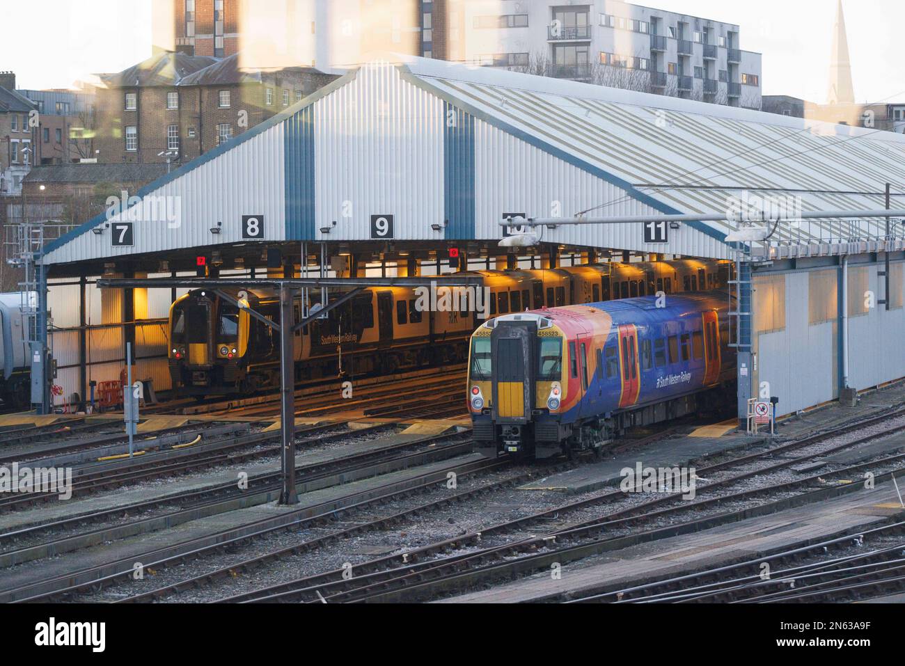 Trains at a train depot at Clapham Junction rail station. Train driver ...
