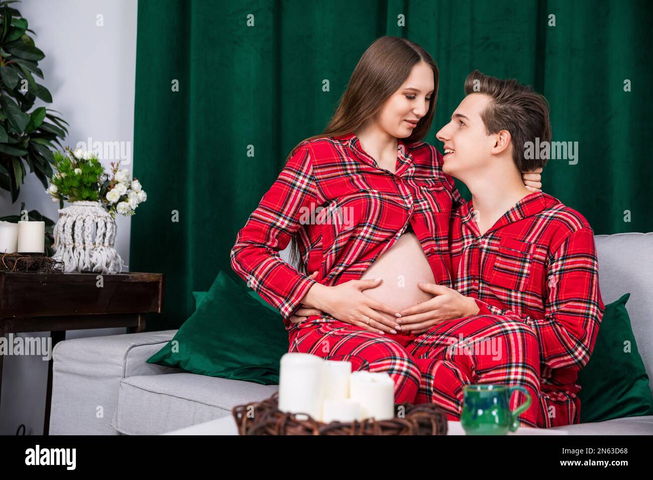 Boy and girl look deeply into each other's eyes as she sits on his lap Stock Photo - Alamy