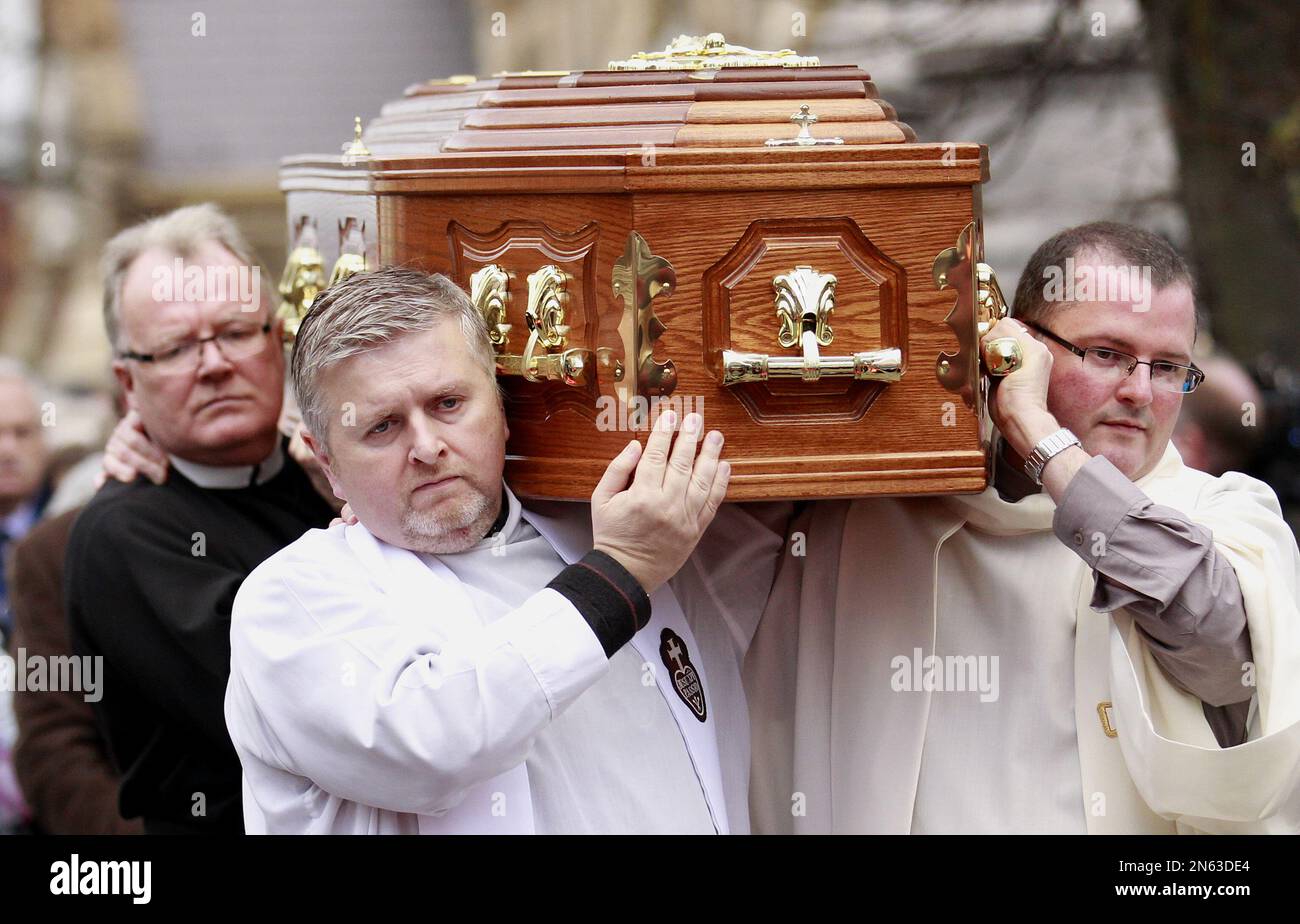 Priests carry the coffin of Catholic Priest Alec Reid from Clonard ...
