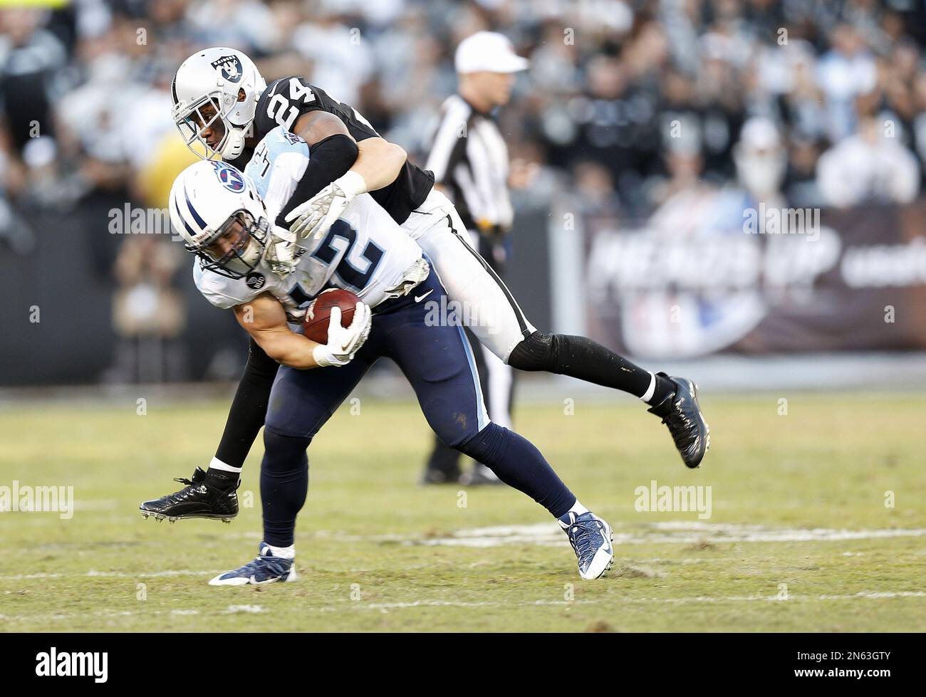 Oakland Raiders cornerback Charles Woodson (24) tackles Tennessee ...