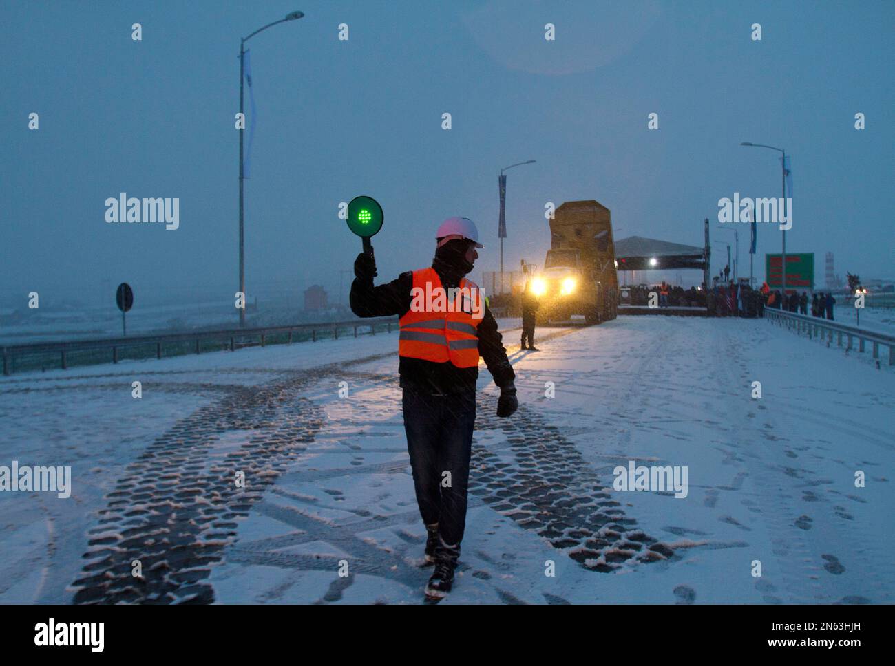 A construction worker directs traffic, at the opening ceremony of the ...