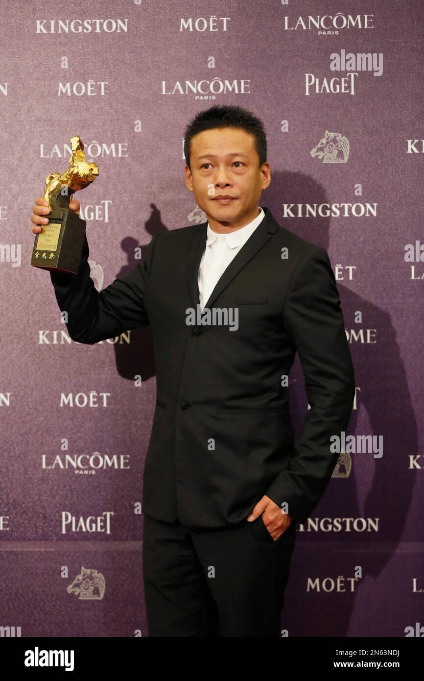 Best Leading Actor Taiwan's Lee Kang Sheng holds his award for his film ...