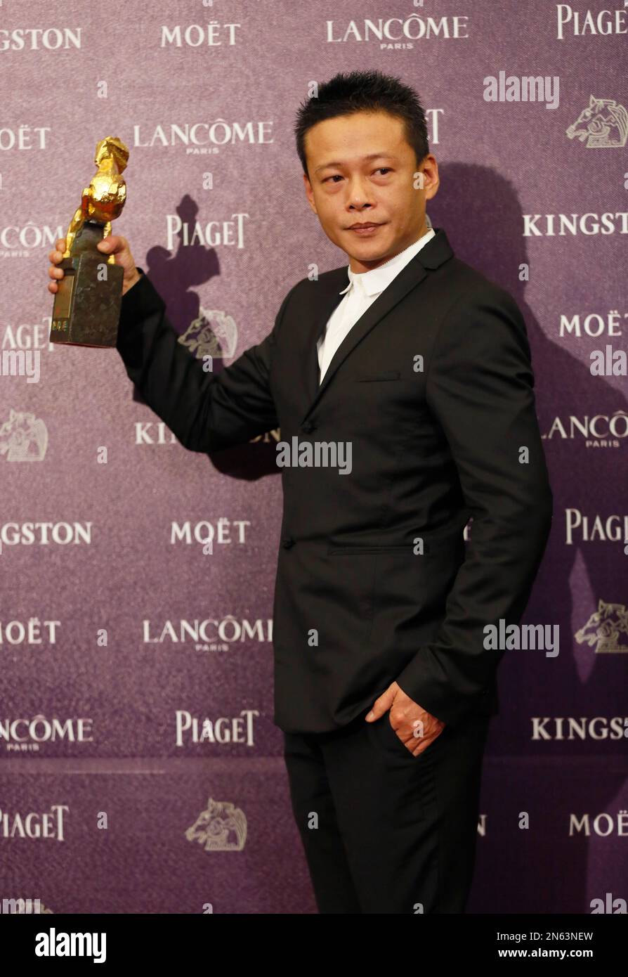 Best Leading Actor Taiwan's Lee Kang Sheng holds his award for his film ...