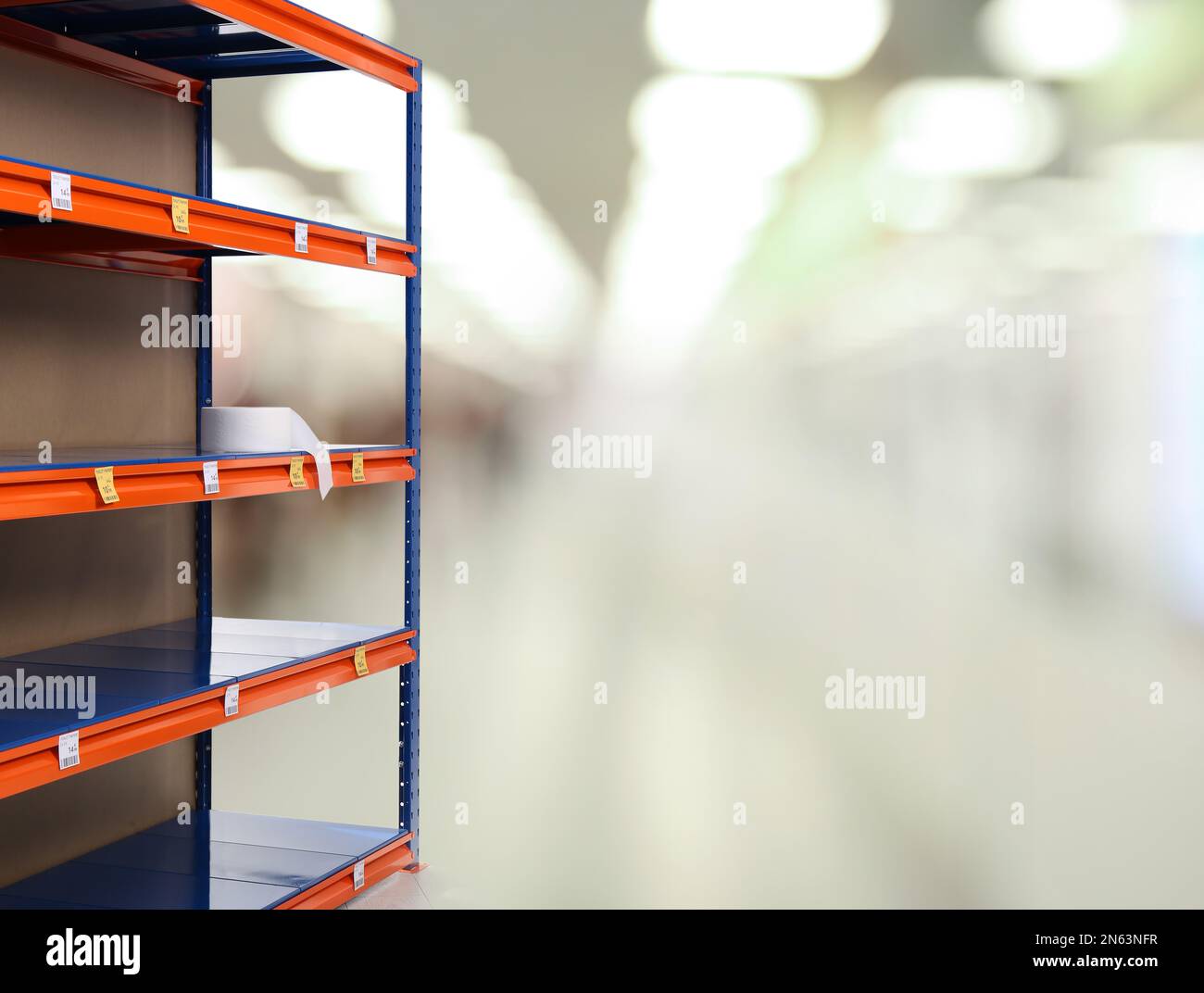 Almost empty shelves in supermarket, closeup. Product deficiency due to ...