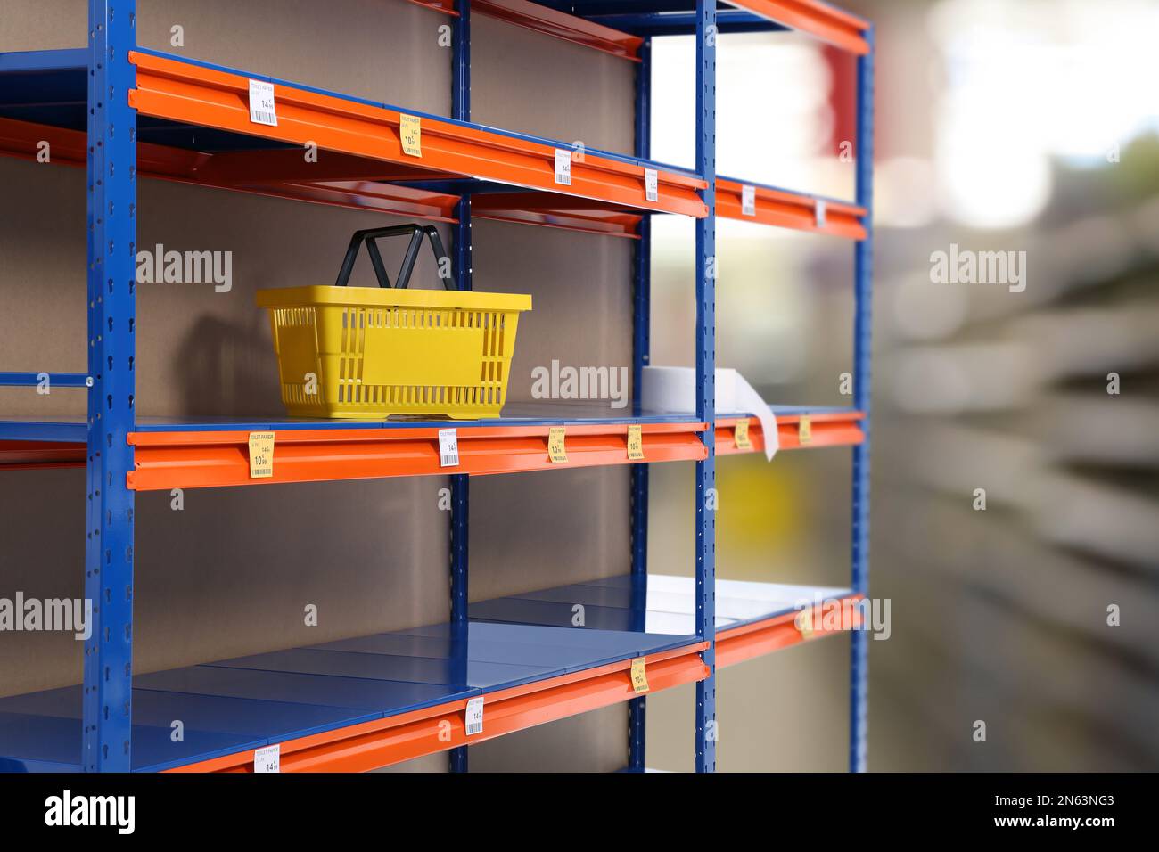Almost empty shelves in supermarket, closeup. Product deficiency due to ...