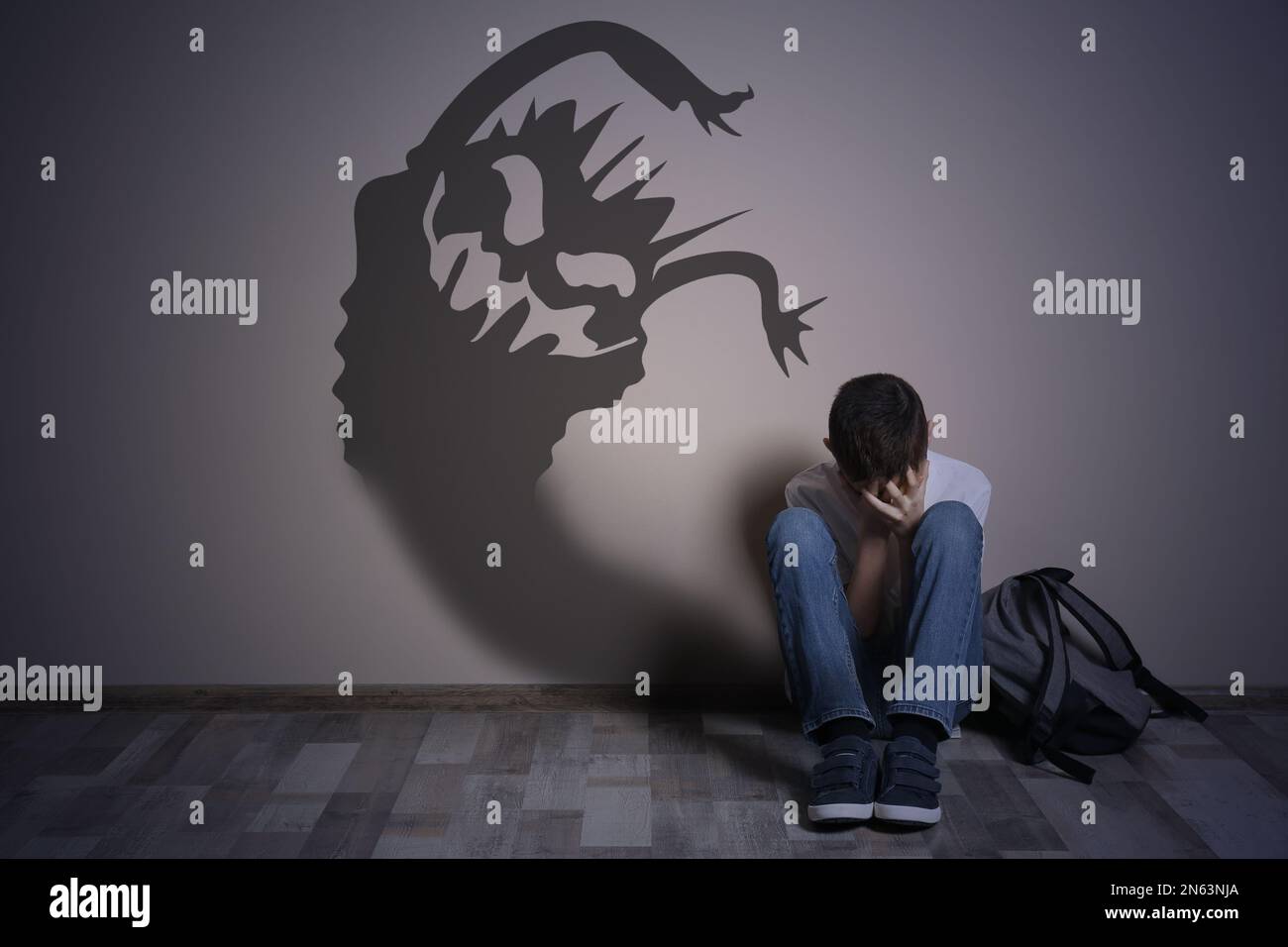 Shadow of monster on wall and scared boy in room Stock Photo - Alamy