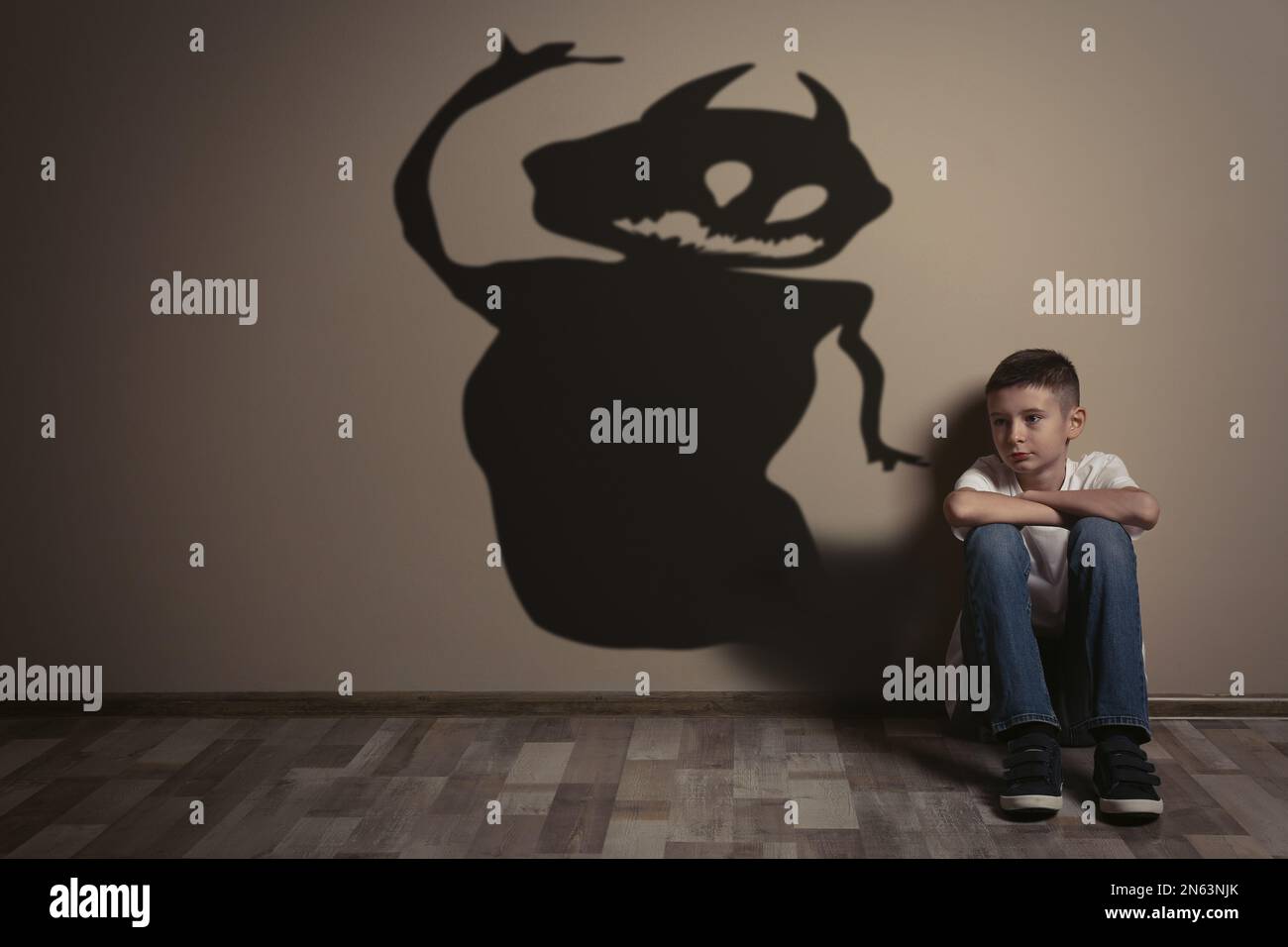 Shadow of monster on wall and upset boy in room Stock Photo - Alamy