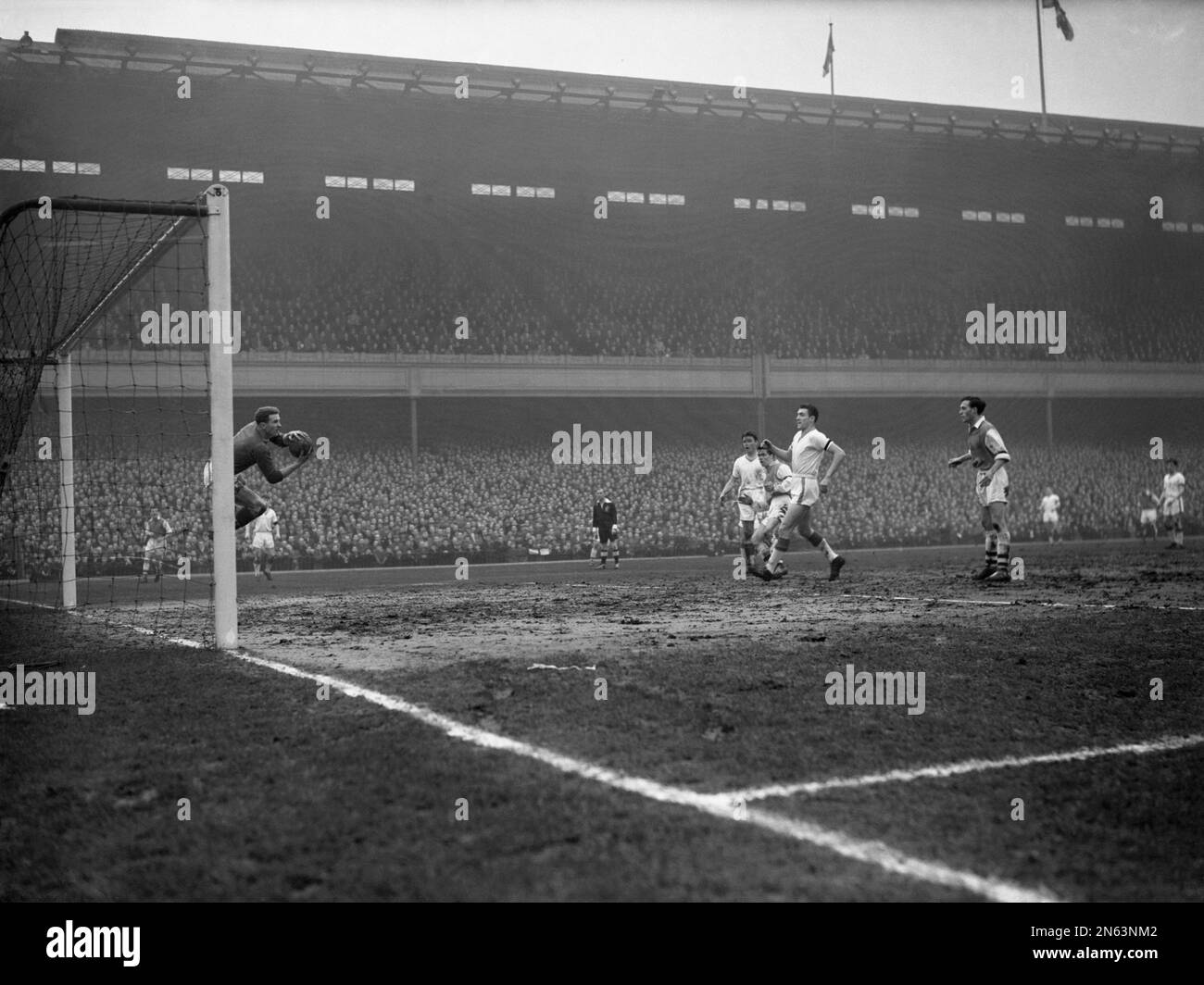 Manchester United goalkeeper Harry Gregg leaps and twists to save a hot ...