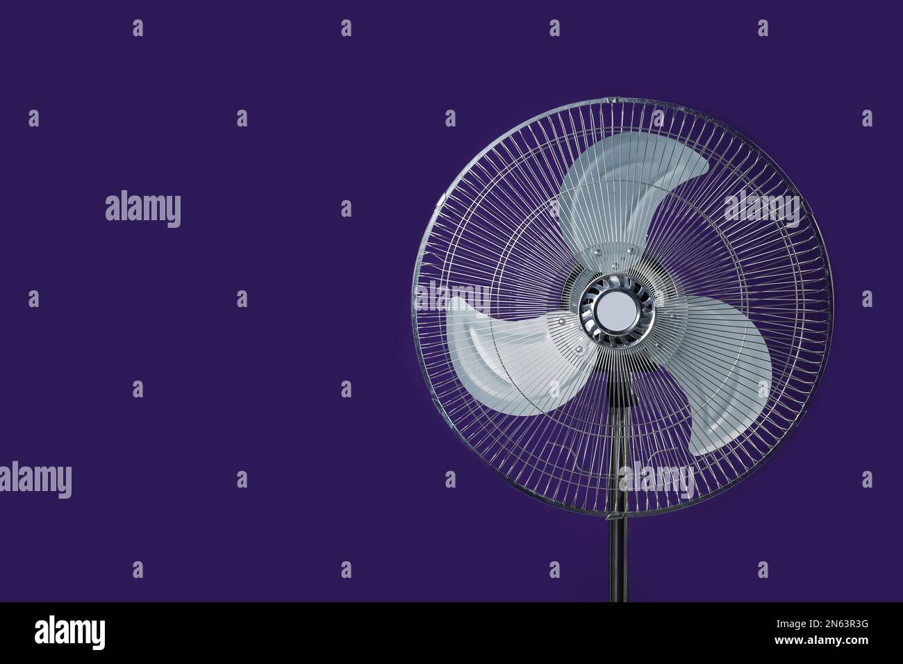 Modern electric fan on violet background. Space for text Stock Photo ...