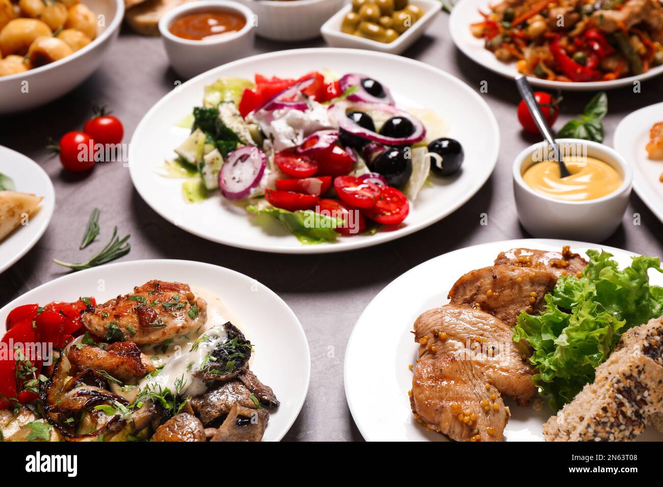 Buffet service. Many different dishes on grey table Stock Photo - Alamy