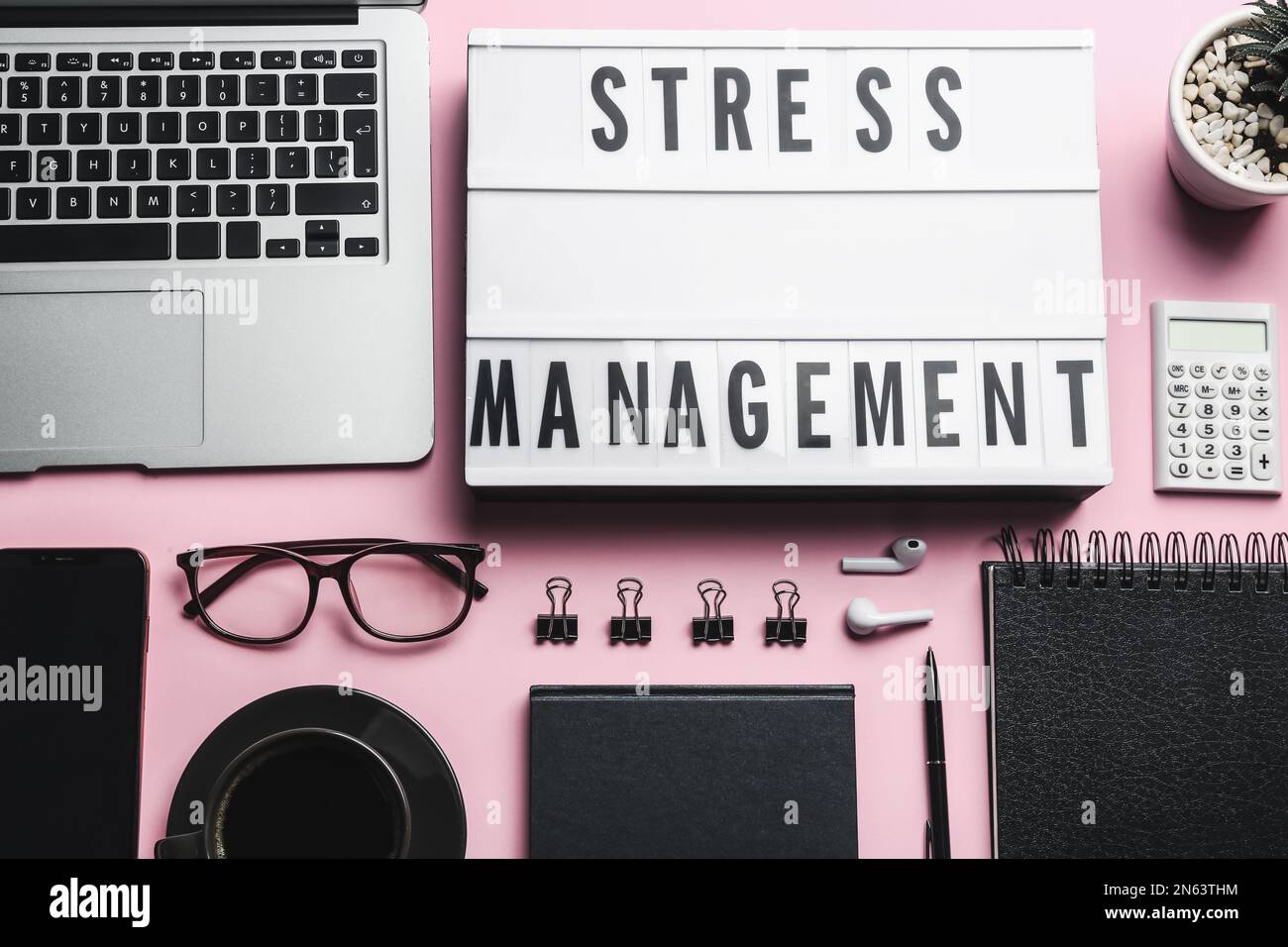 Flat lay composition of lightbox with phrase Stress Management on pink ...
