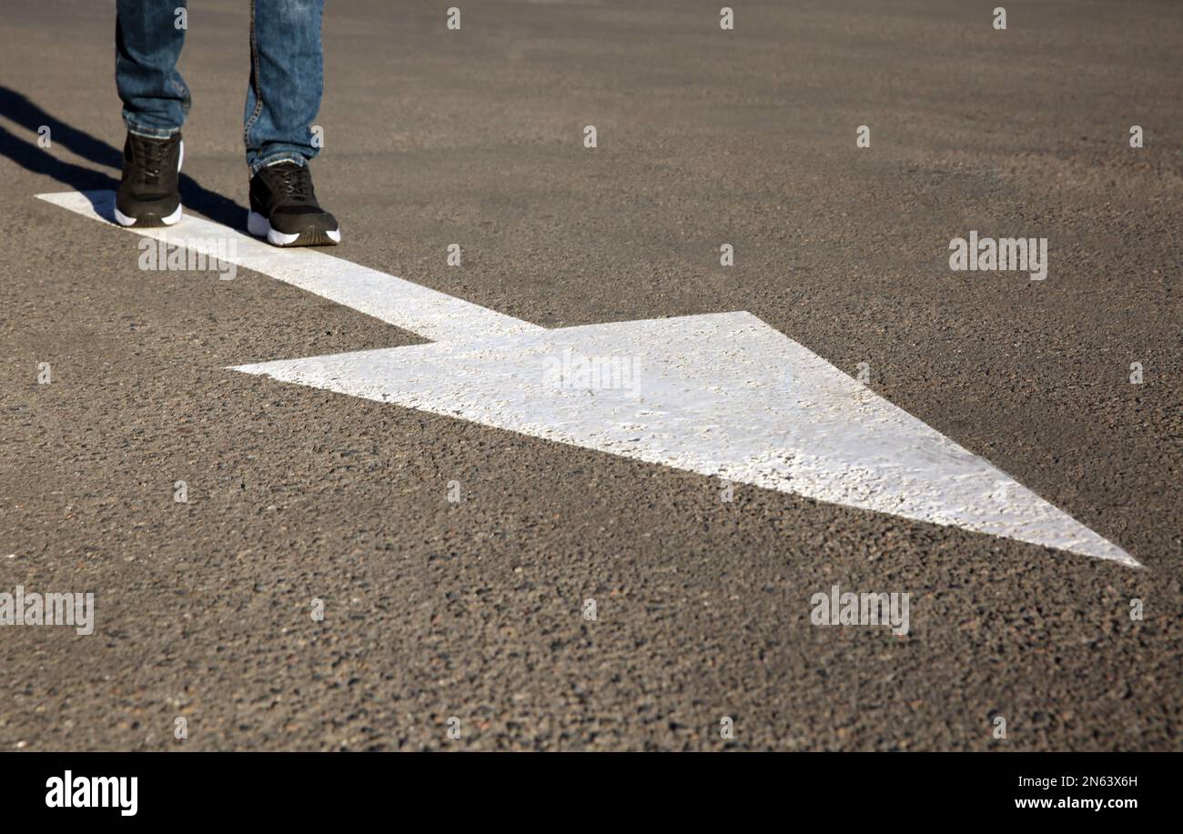 White road marking arrow pointing hi-res stock photography and images ...