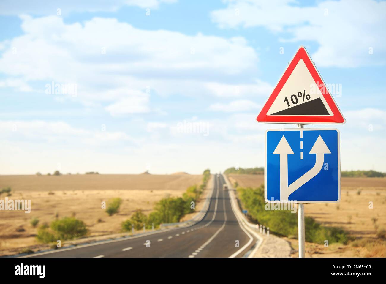Traffic signs near empty asphalt highway. Road trip Stock Photo - Alamy