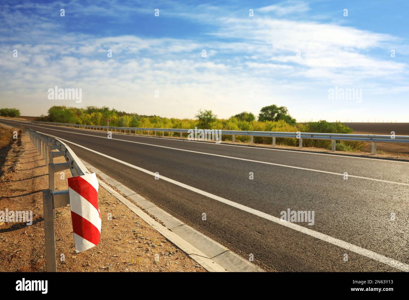 Guard rail and empty asphalt highway. Road trip Stock Photo - Alamy