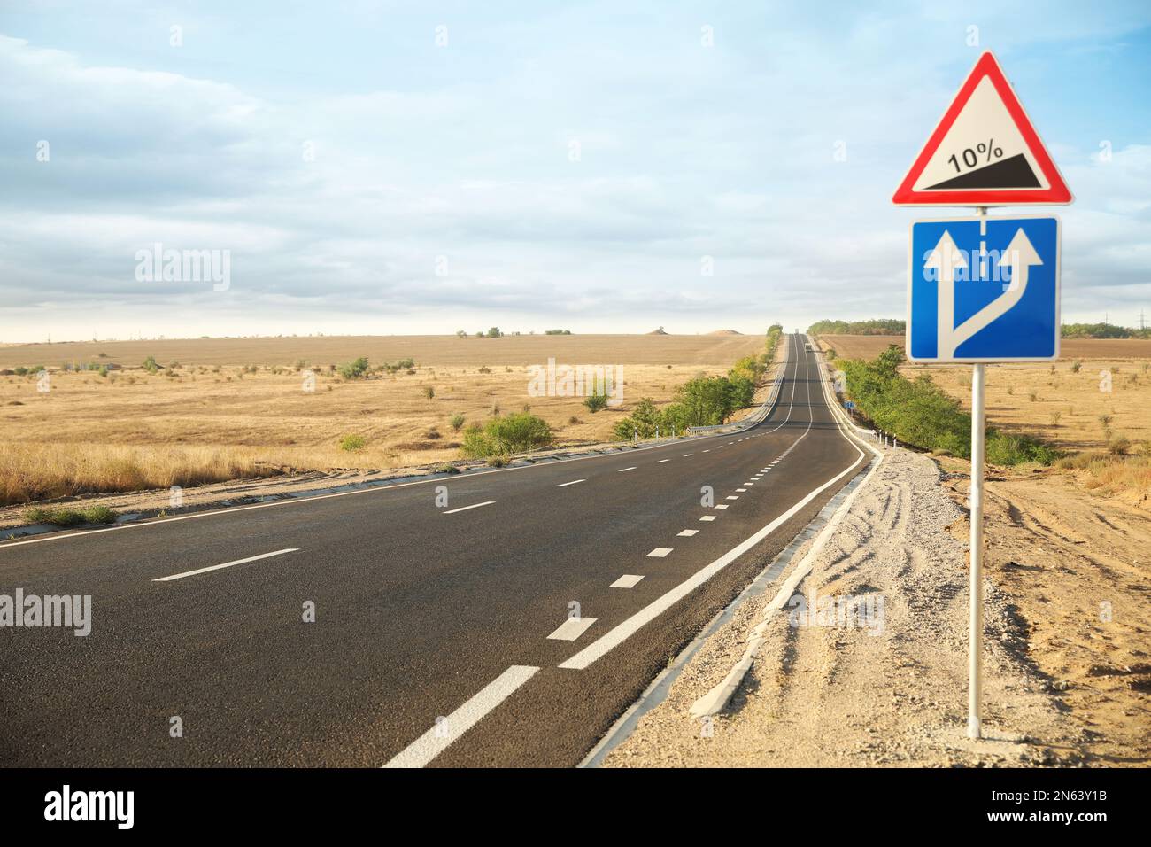 Traffic signs near empty asphalt highway. Road trip Stock Photo - Alamy