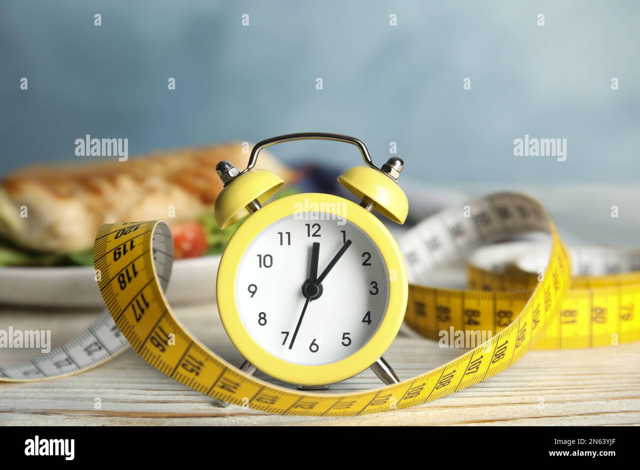Alarm clock measuring tape wooden table hi-res stock photography and ...