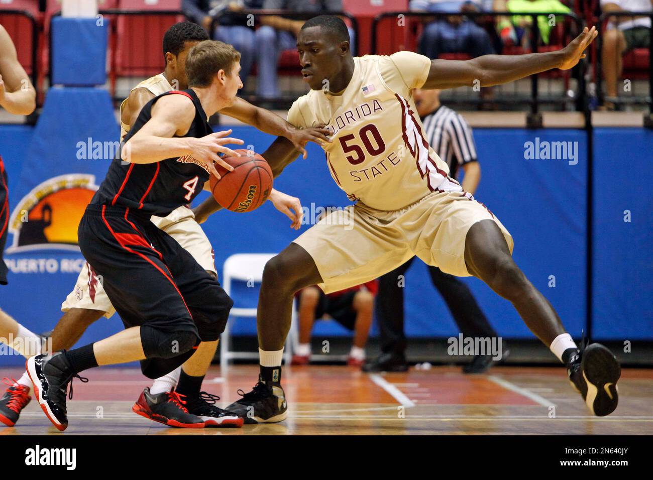 Florida State center Michael Ojo, right, pressures Northeastern guard ...