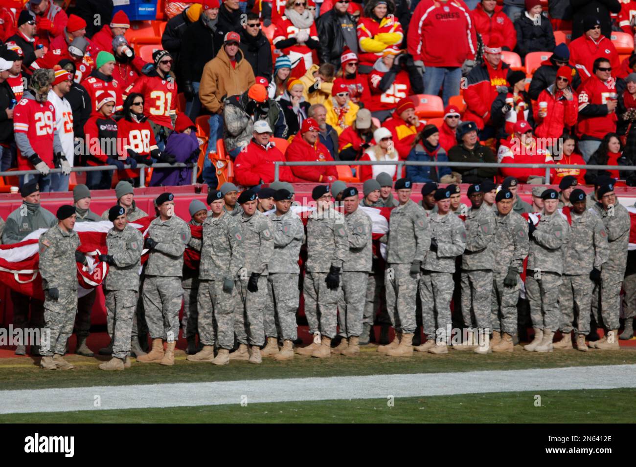 Soldiers hold a giant flag before an NFL football game between the San ...
