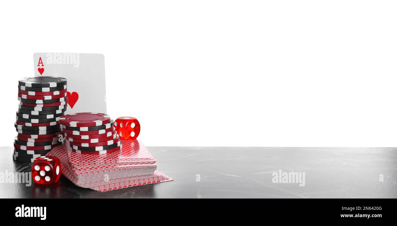 Gaming chips, dice and cards on table against white background Stock ...