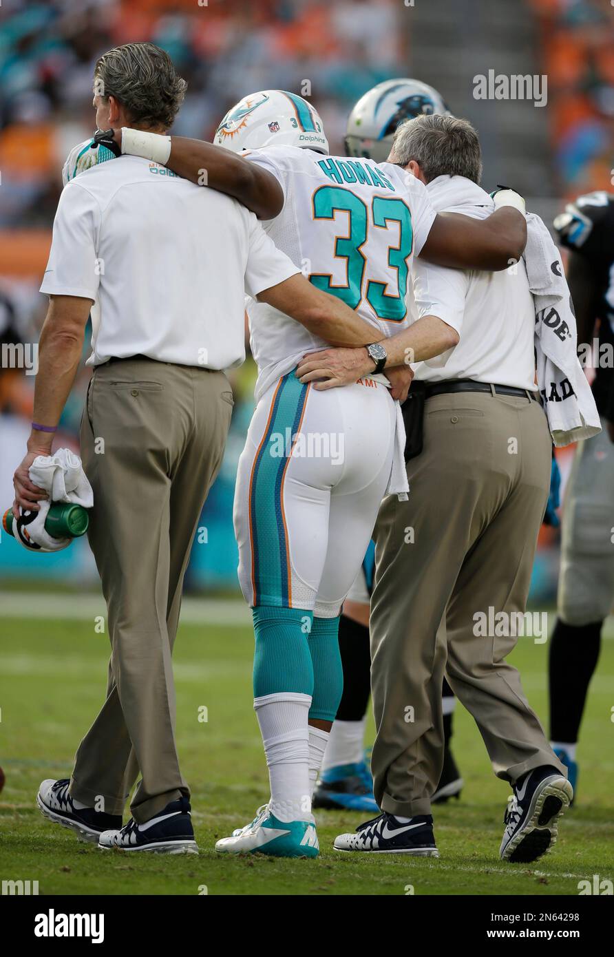 Miami Dolphins running back Daniel Thomas (33) is helped off the field ...