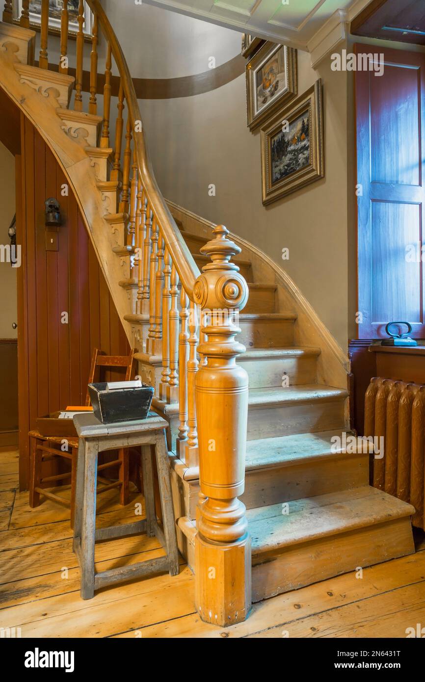 Curved wooden staircase with fancy post and balusters on ground floor ...