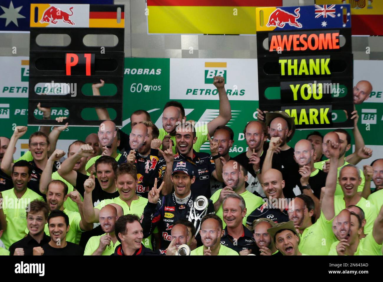 Red Bull driver Mark Webber of Australia, center, poses for photos with ...