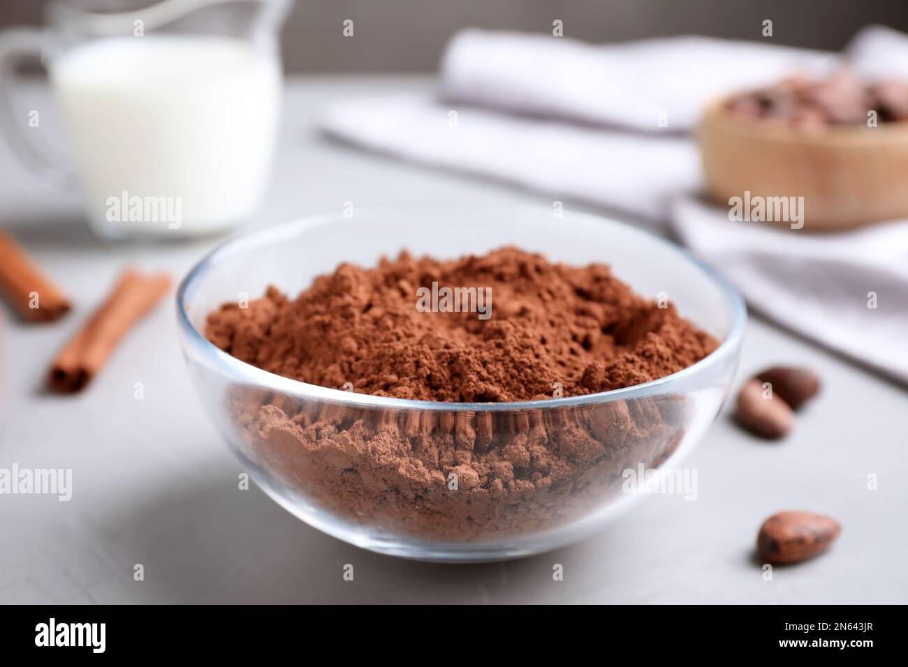 Cocoa powder in bowl on light table Stock Photo - Alamy