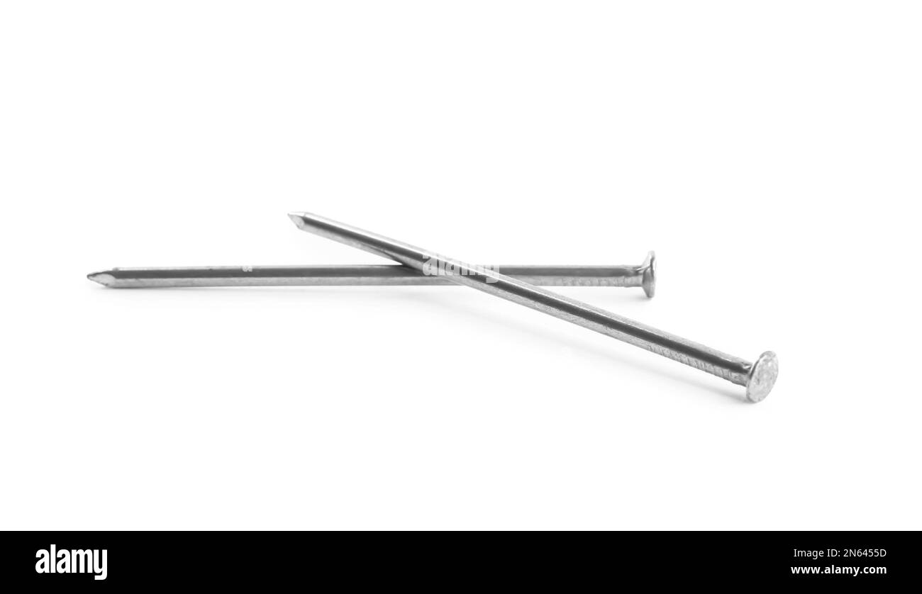 Sharp shiny metal nails on white background Stock Photo - Alamy